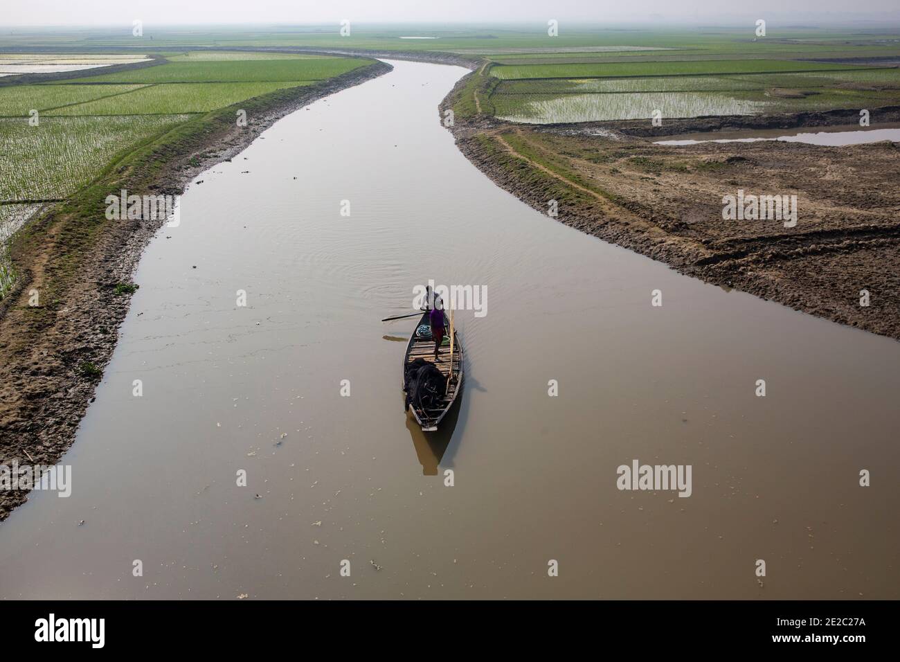 Fisherman rowing boat on the Titas River in Brahmanbaria, Bangladesh ...
