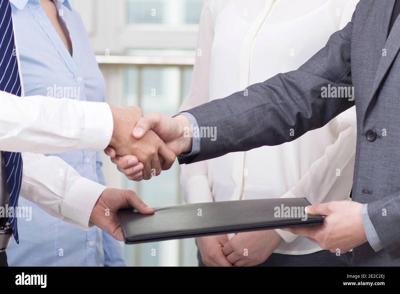 Business men shaking hands at office high quality photo Stock Photo - Alamy