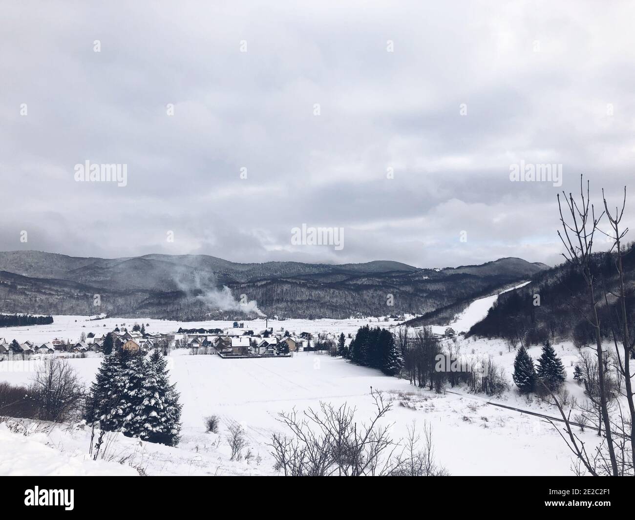 Small rural village surrounded by snow mountains hi-res stock ...