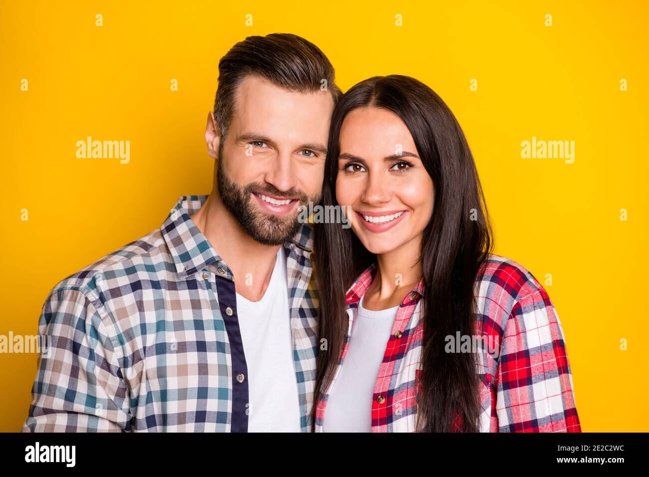 Portrait of two lovely tender cheerful amorous people embracing ...