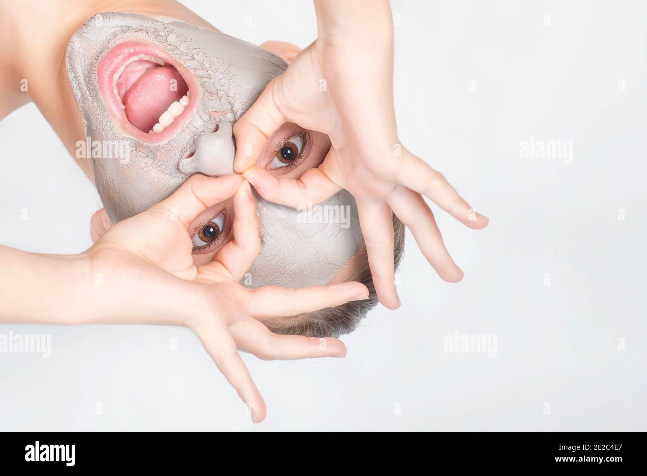 Beauty procedures skin care concept. Young woman applying facial gray ...