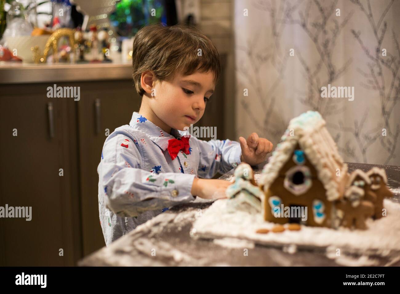 Cute boy making cookie Stock Photo - Alamy