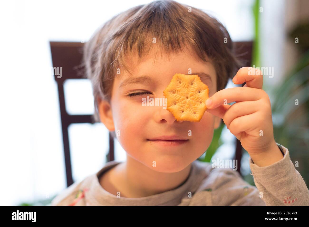 Cute boy making cookie Stock Photo - Alamy