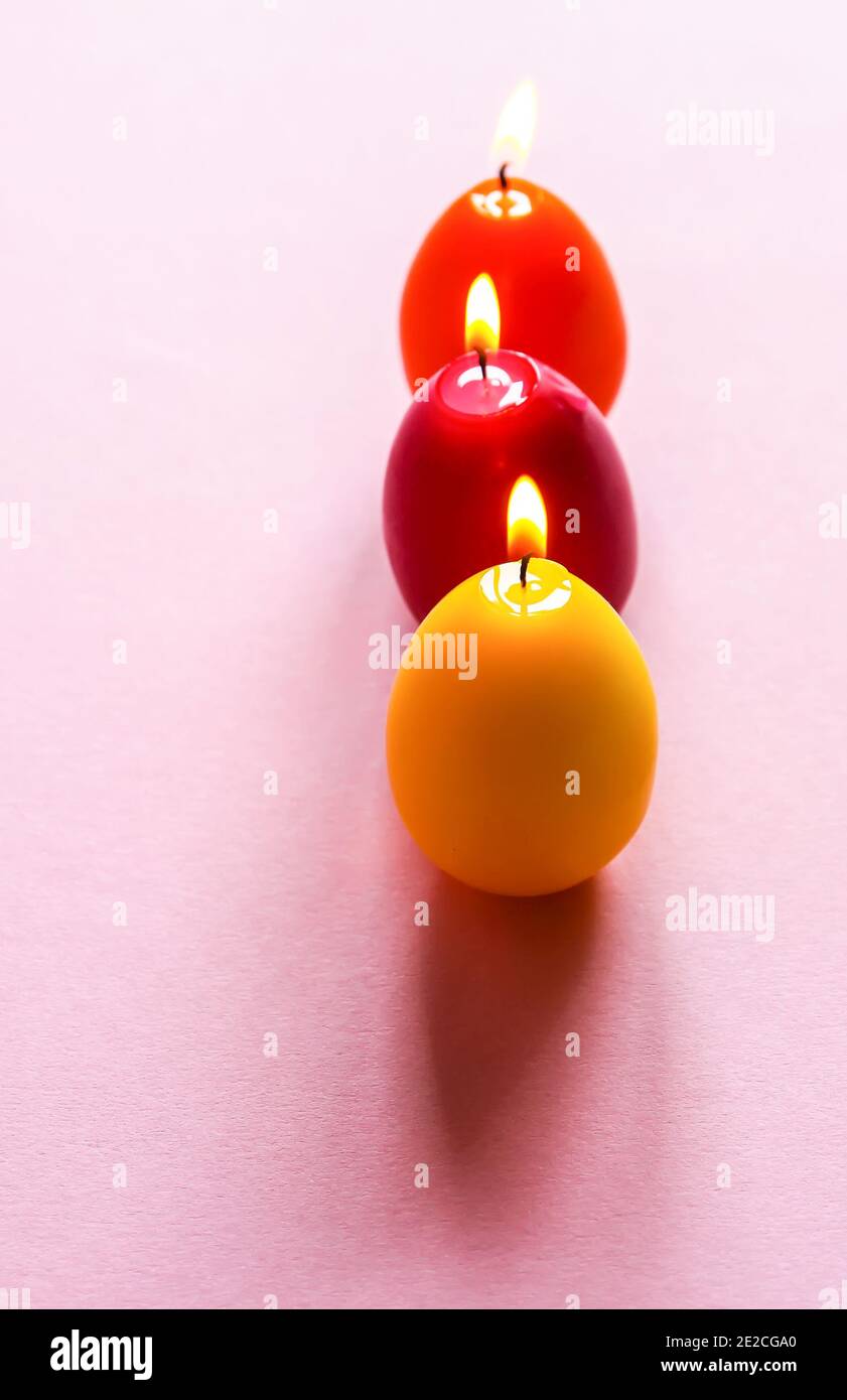 Traditional Easter decor. Group of bright burning paraffin candles in ...