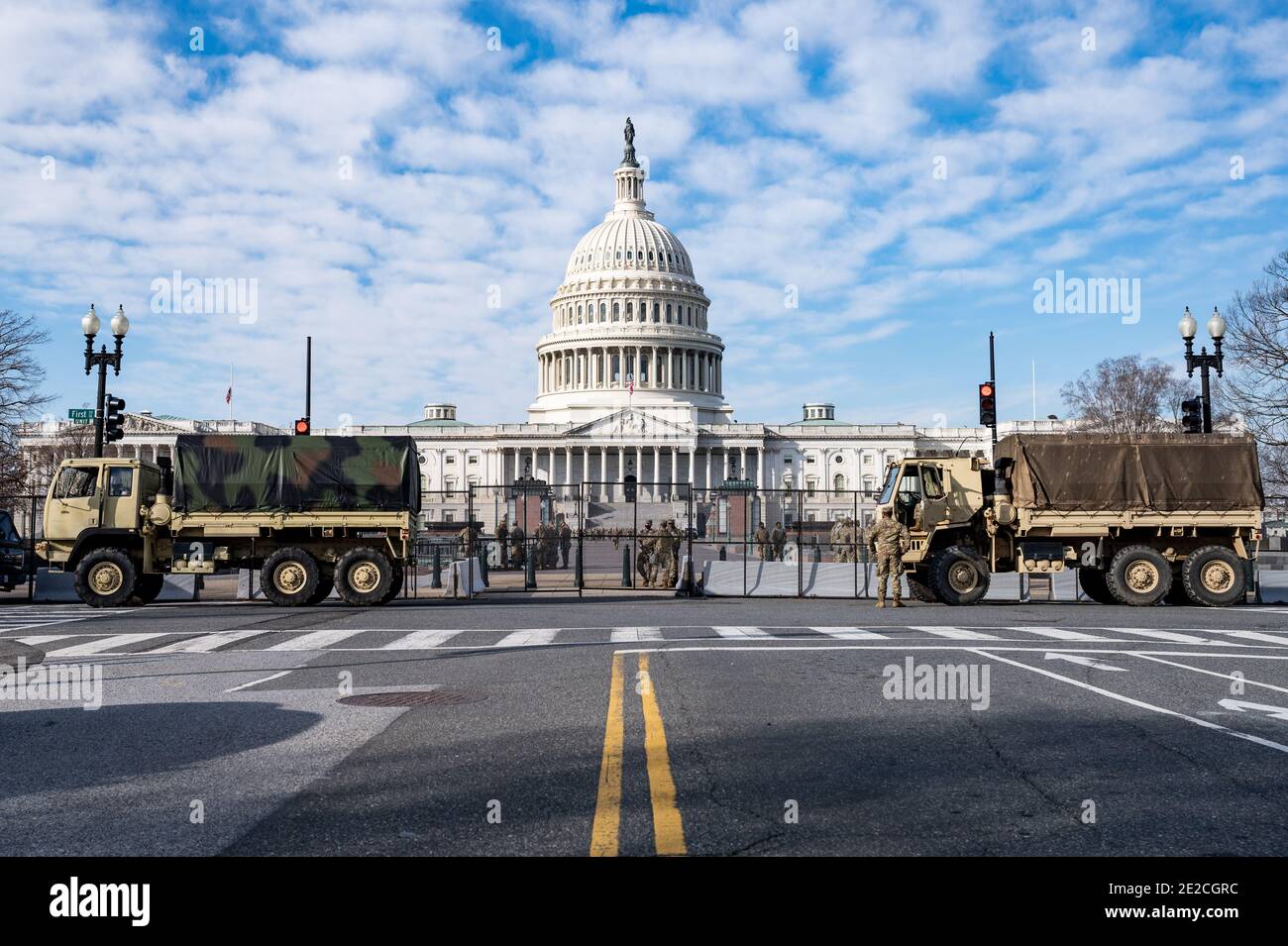 National Guard troops standing guard by non-scalable fencing that was ...