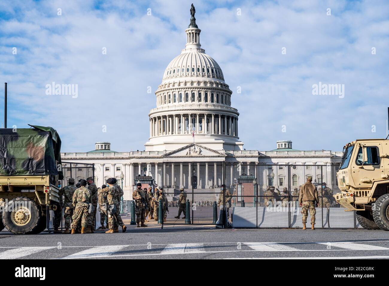 National Guard troops standing guard by non-scalable fencing that was ...