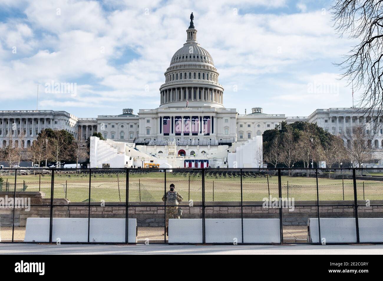 National Guard troops standing guard by non-scalable fencing that was ...