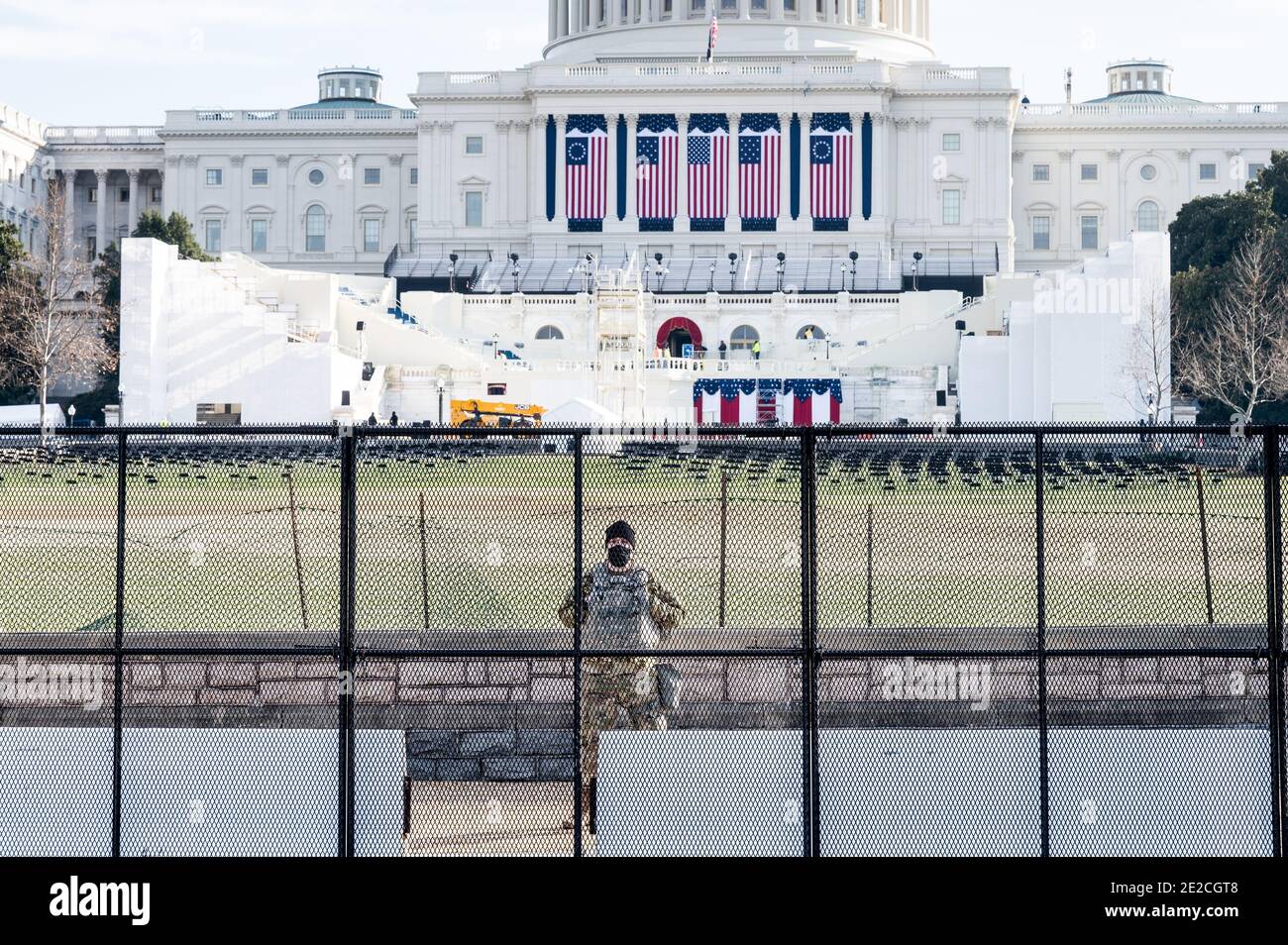 National Guard troops standing guard by non-scalable fencing that was ...
