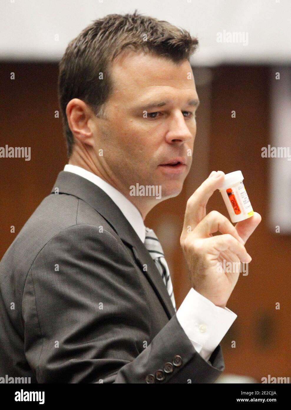 Deputy District Attorney David Walgren holds a prescription bottle as ...