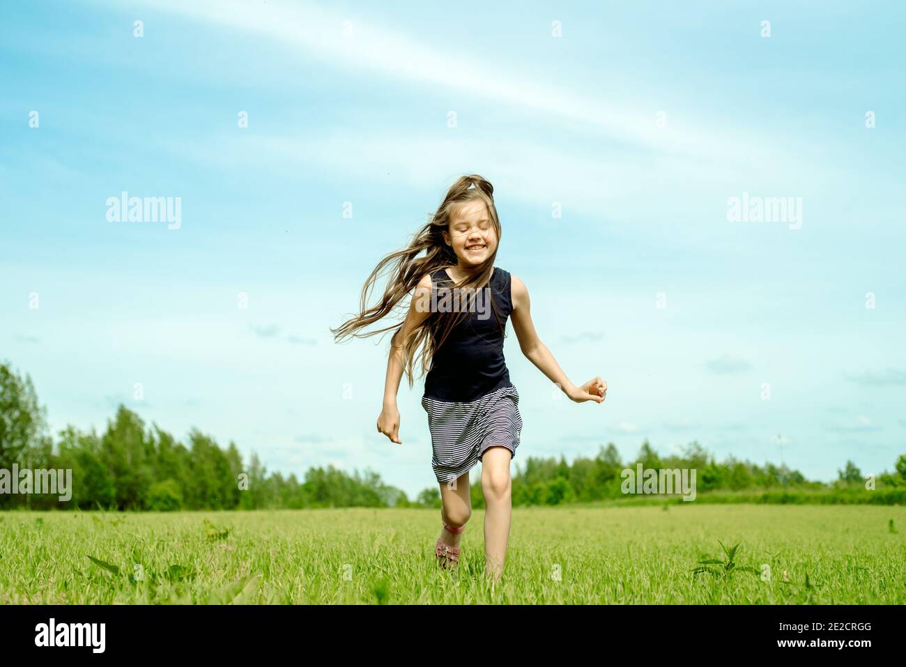 Little girl running on a meadow in a field of flowers, Freedom ...