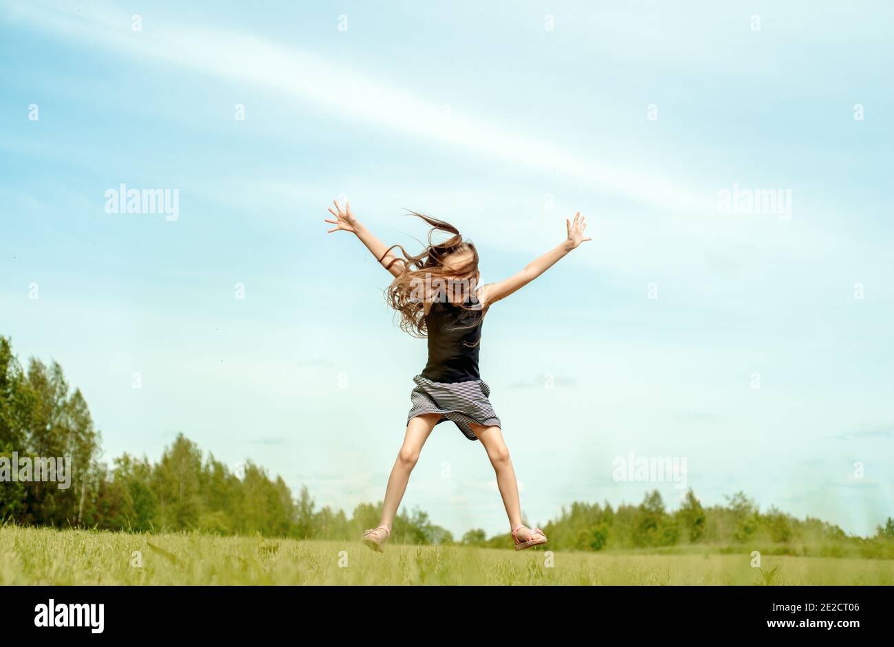 Girl, jumping in the field.running and jumping. happy childhood, hot ...