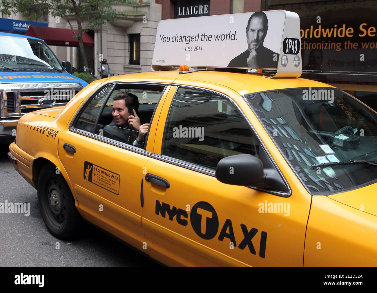 Sign for Steve Jobs "You changed the world" on the top of a yellow cab ...
