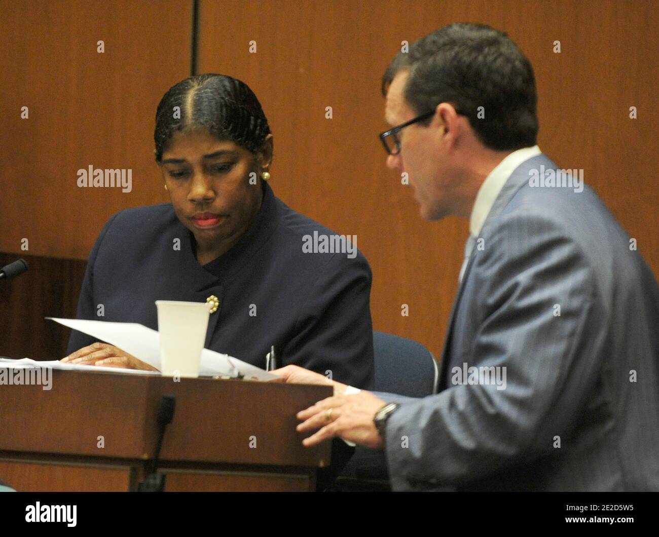 Defense attorney Ed Chernoff (R) approaches witness Cherilyn Lee (L), a ...