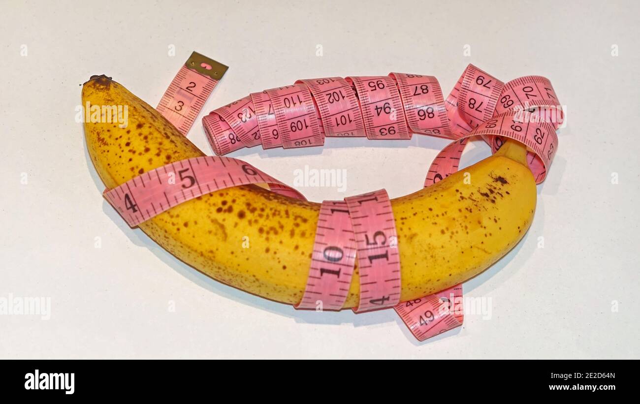 One big banana with measuring tape concept Stock Photo - Alamy