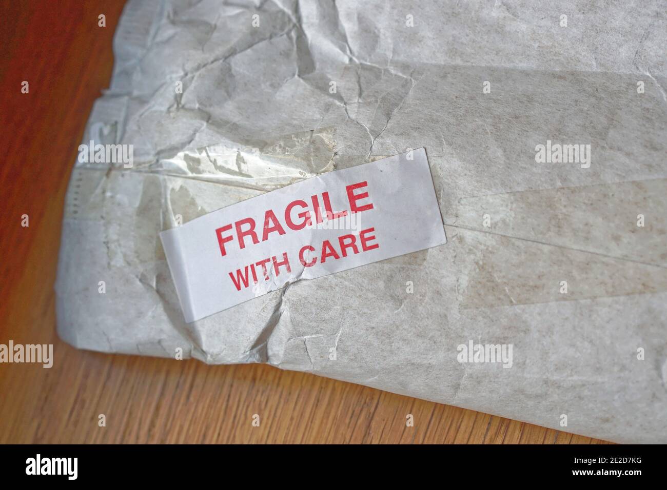 Fragile with care sticker at mail package Stock Photo - Alamy