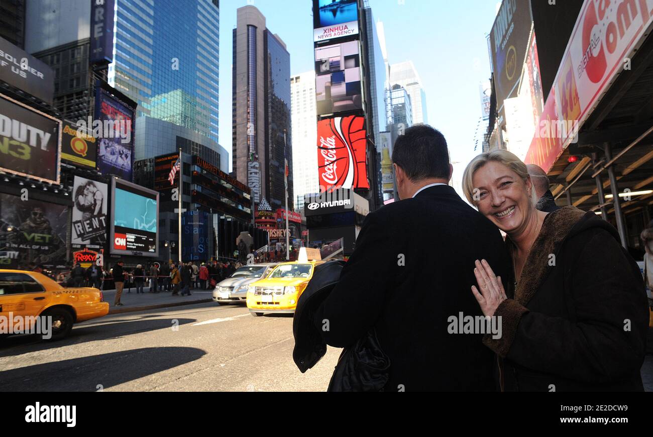French presidential candidate Marine Le Pen walks with her partner ...