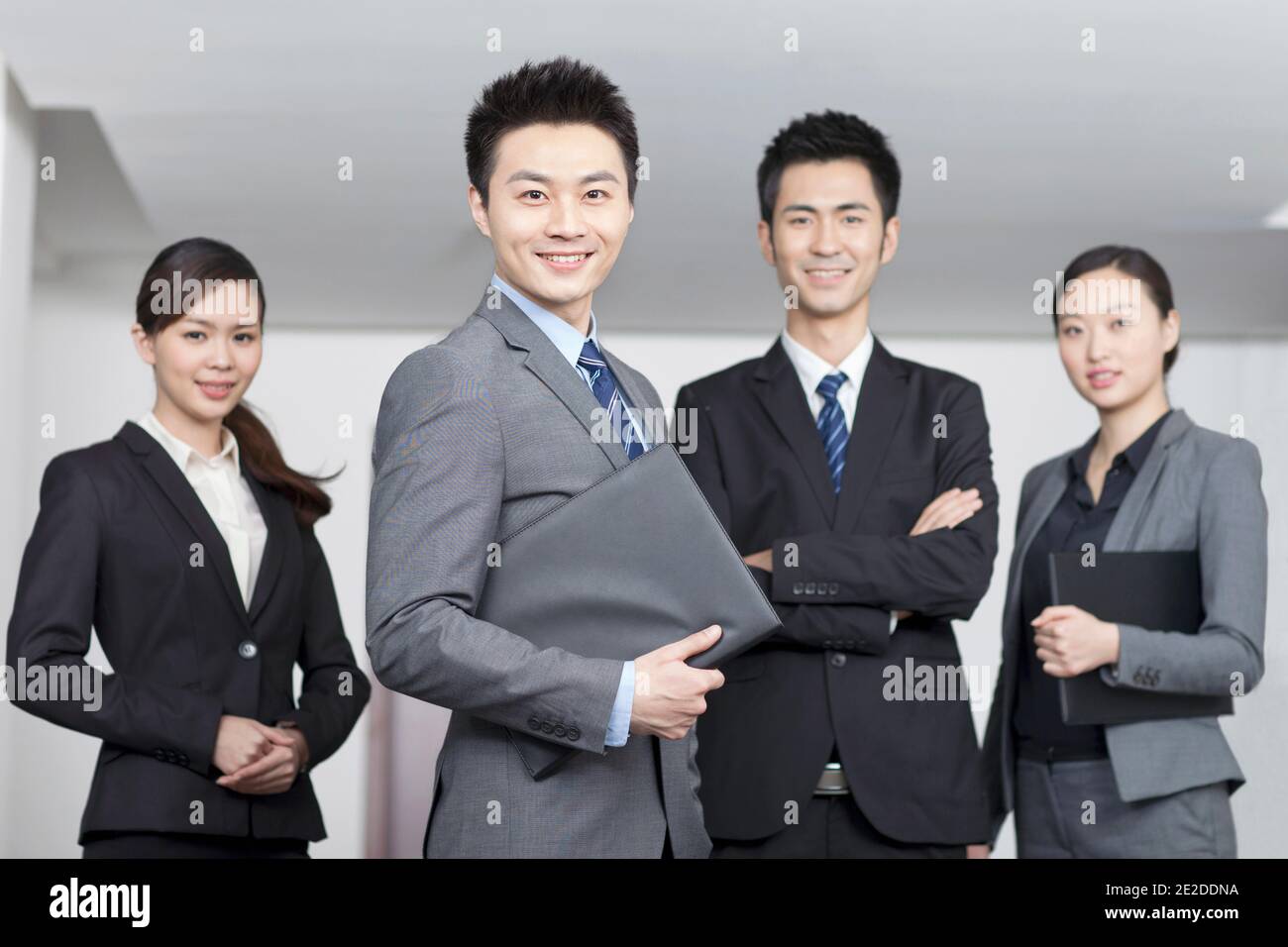 Four young office workers with hands crossed indoors,portrait high quality photo Stock Photo - Alamy