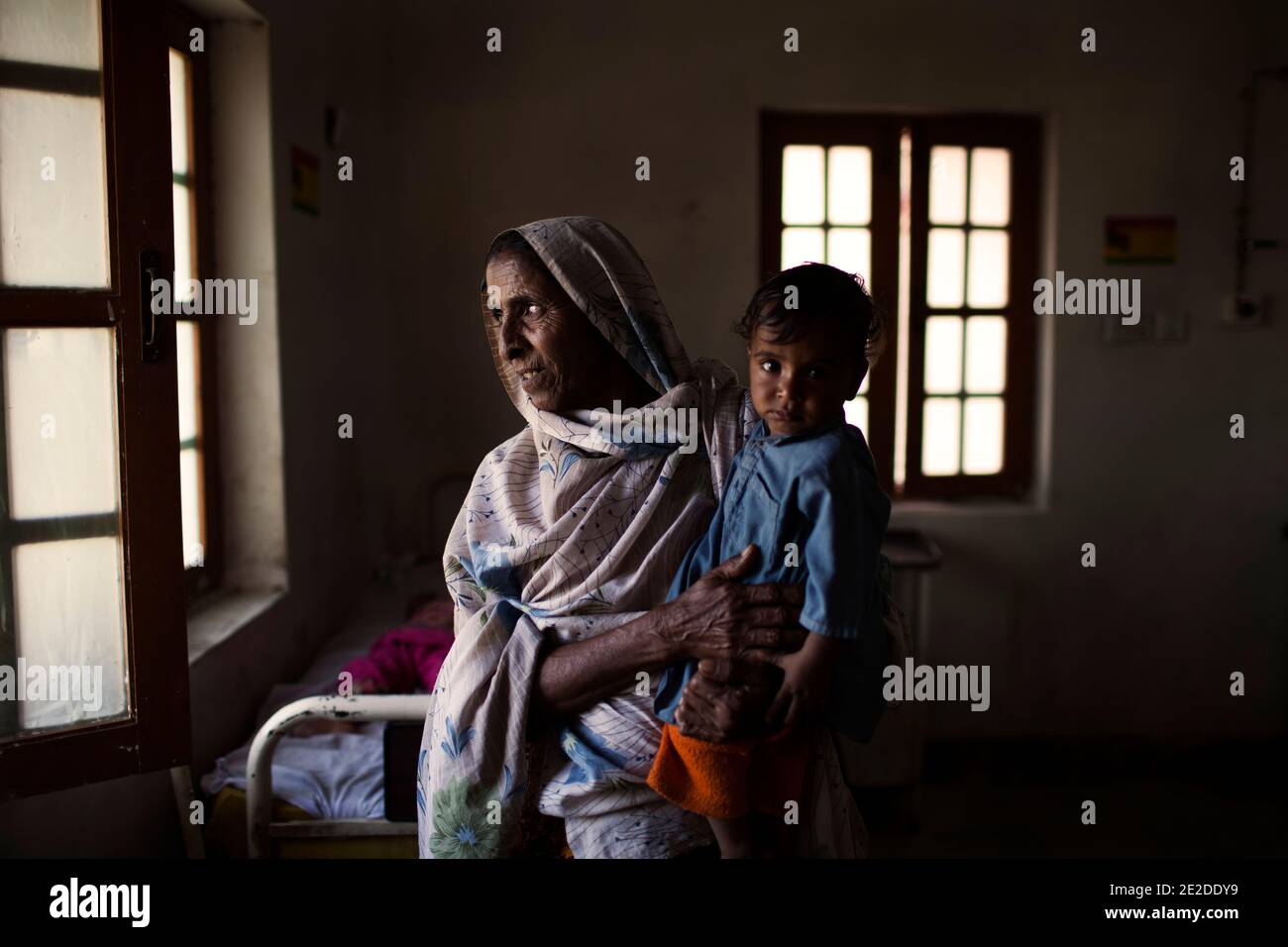A mother holding her son at the DTC- Tando Allah Yar, in Mir pur Khas ...