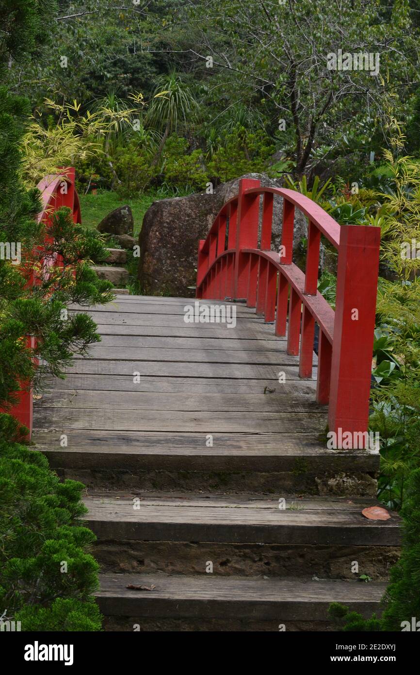 Red Japanese bridge in a garden Stock Photo - Alamy