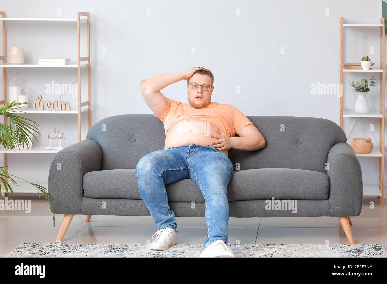 Stressed overweight man at home. Weight loss concept Stock Photo - Alamy