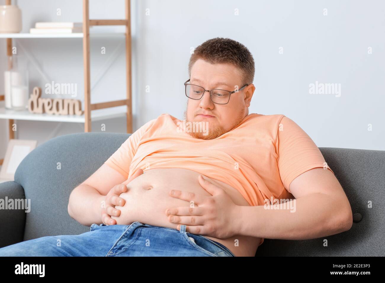 Stressed overweight man at home. Weight loss concept Stock Photo - Alamy