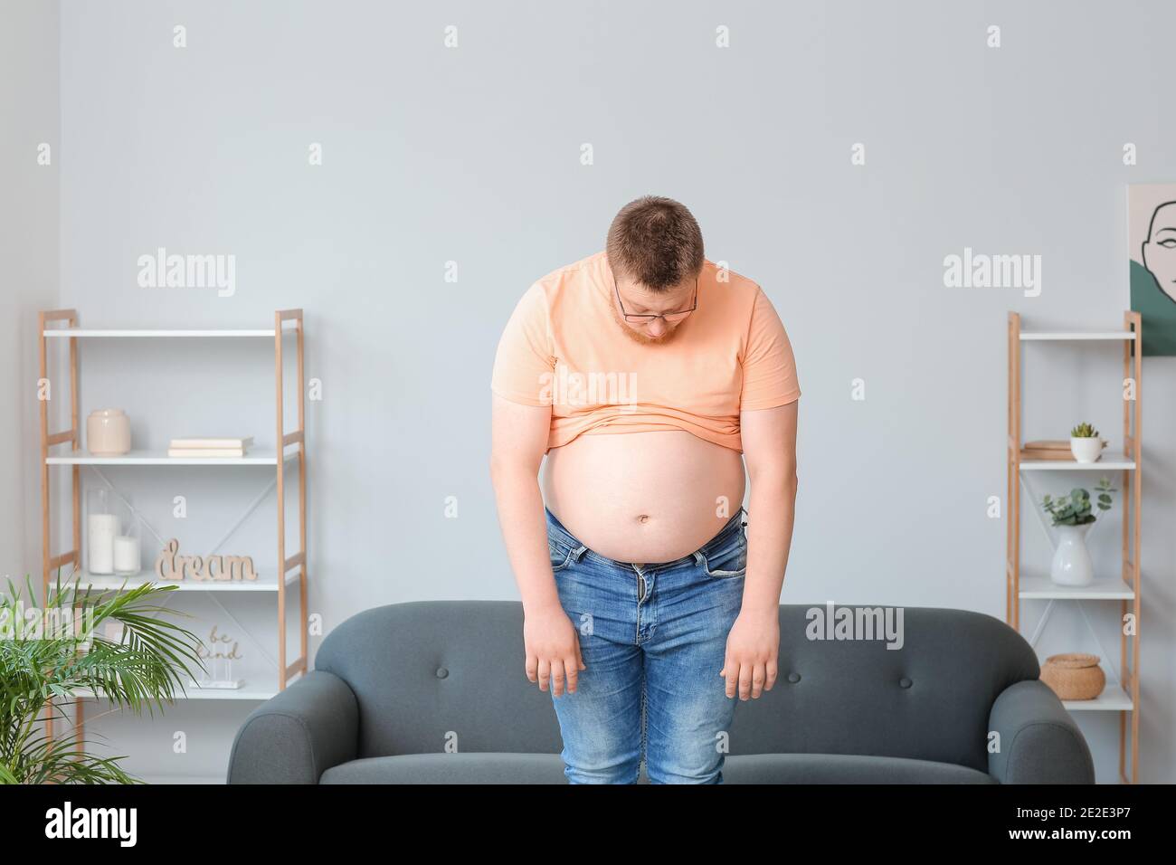 Sad overweight man at home. Weight loss concept Stock Photo - Alamy