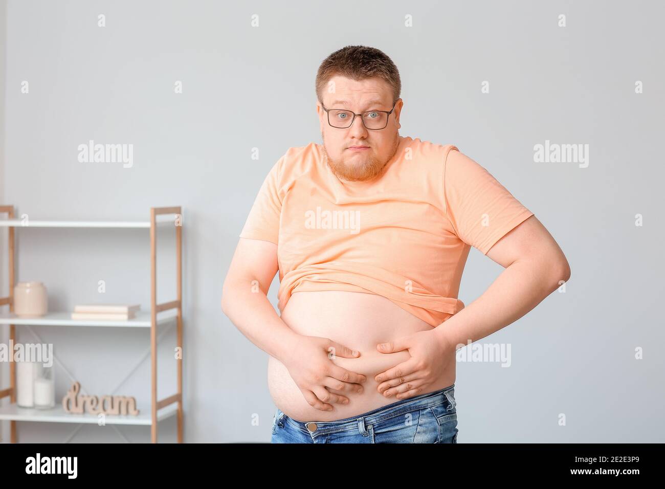 Stressed overweight man at home. Weight loss concept Stock Photo - Alamy