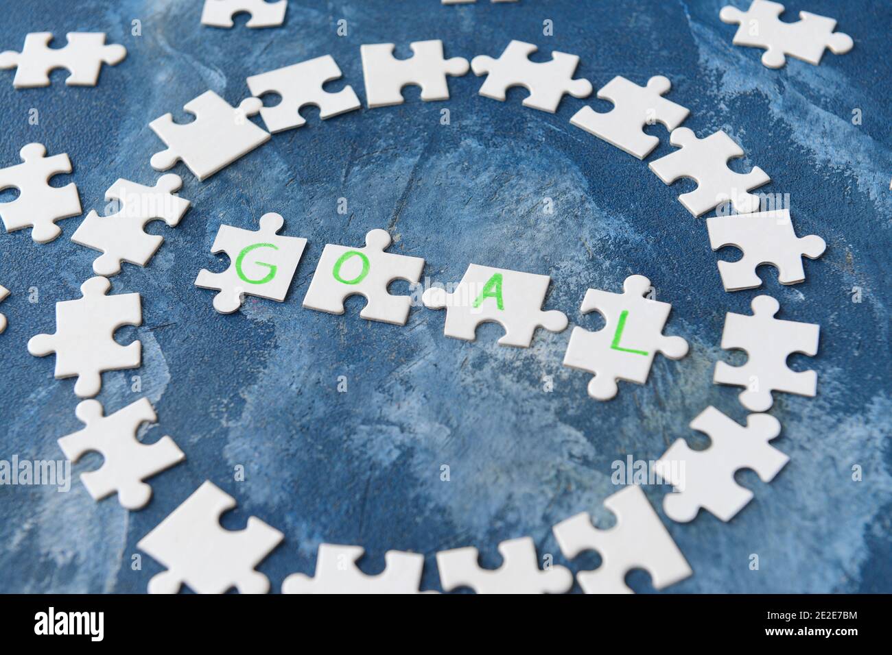 Puzzle pieces with word GOAL on color table Stock Photo - Alamy