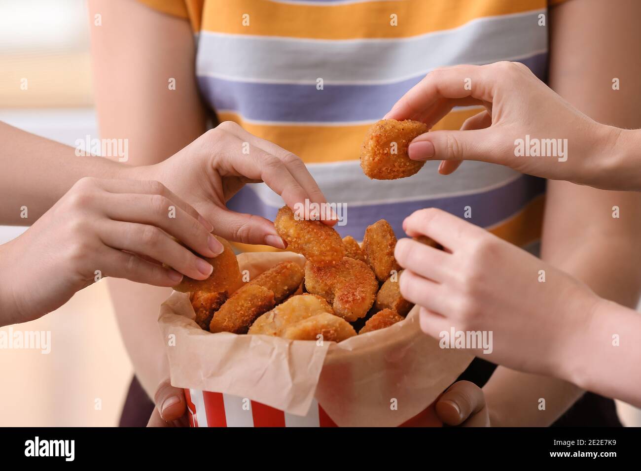 Women eating tasty nuggets hi-res stock photography and images - Alamy