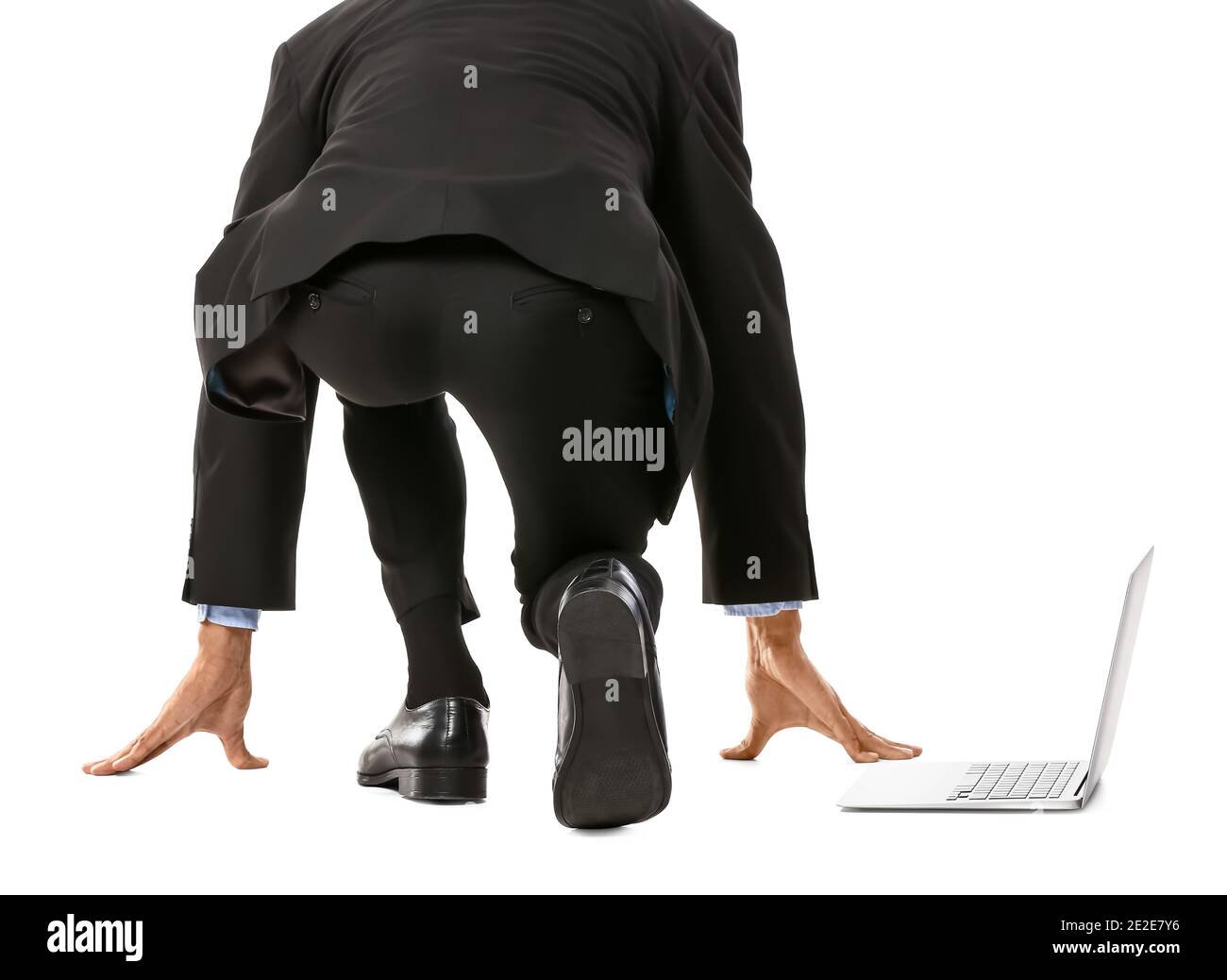 Young businessman standing in crouch start position isolated on white ...