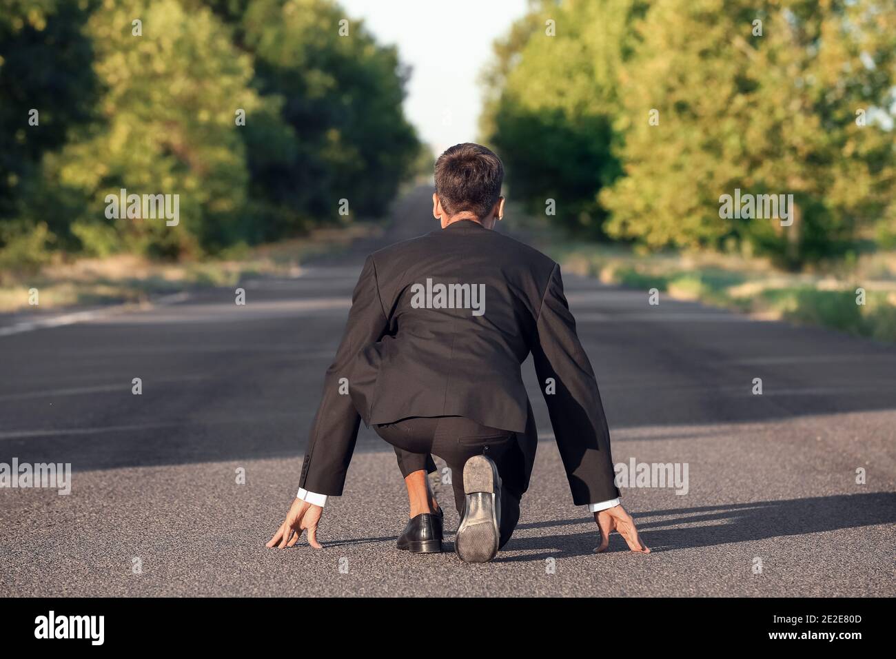 Young businessman standing in crouch start position. Concept of goal ...
