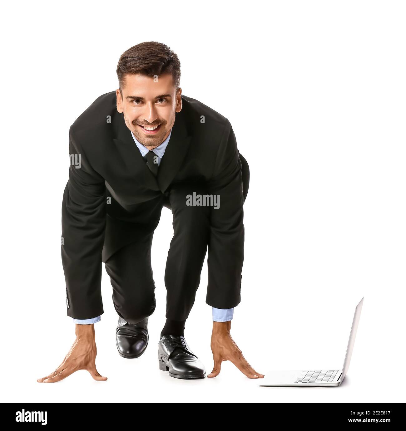 Young businessman standing in crouch start position isolated on white ...