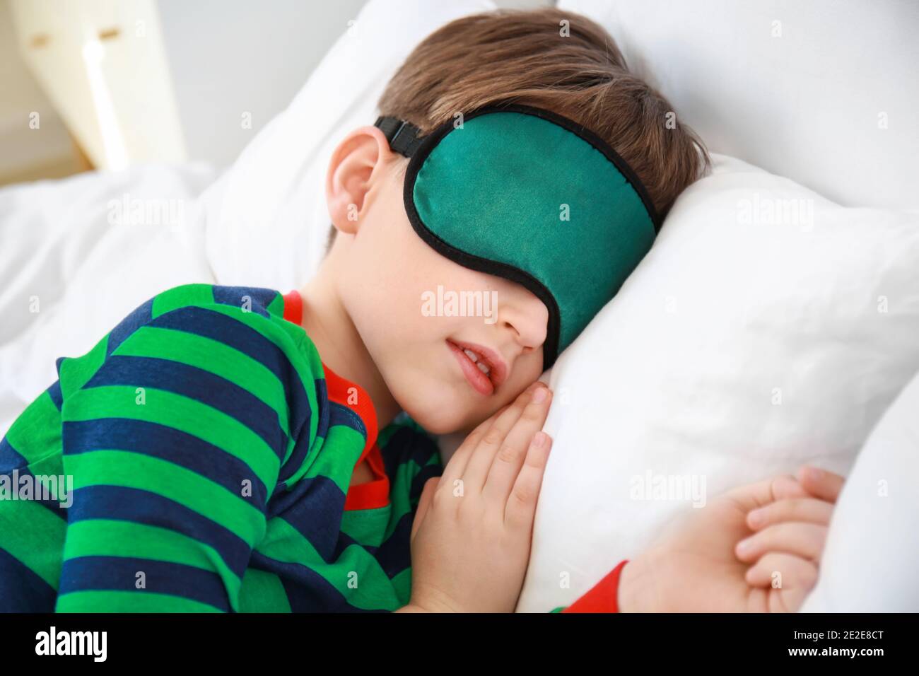 Little boy sleeping in mask on bed at home Stock Photo - Alamy