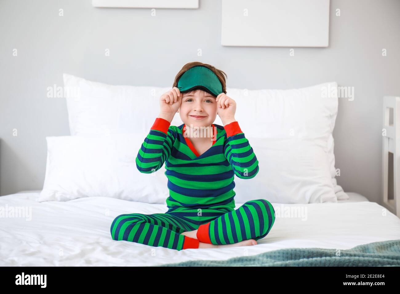 Little boy in sleep mask on bed at home Stock Photo - Alamy