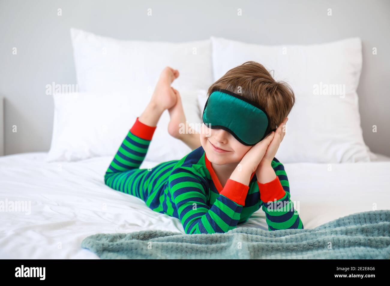 Little boy in sleep mask on bed at home Stock Photo - Alamy