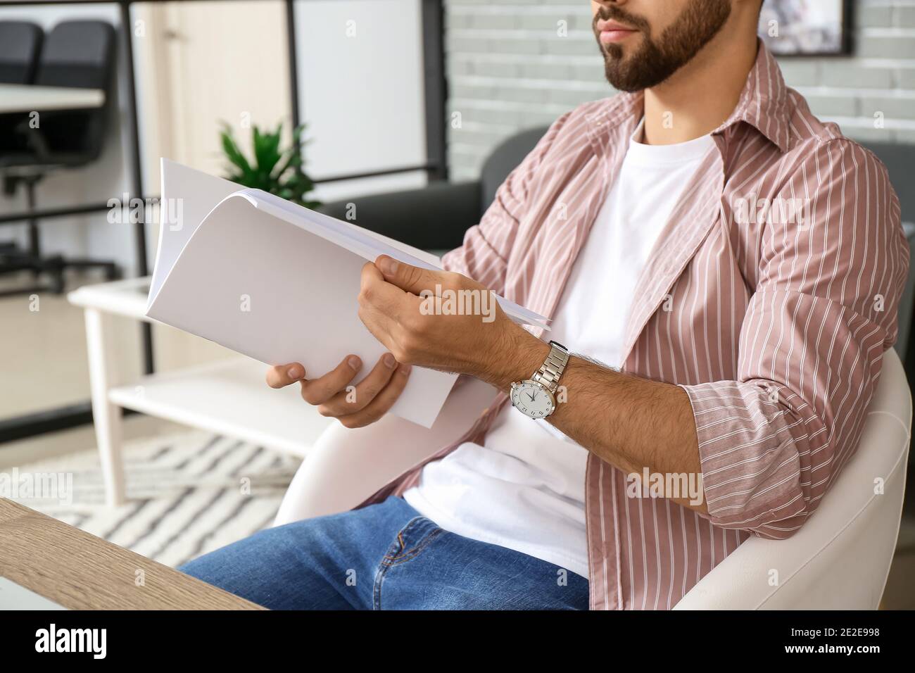 Young man reading magazine at home Stock Photo - Alamy