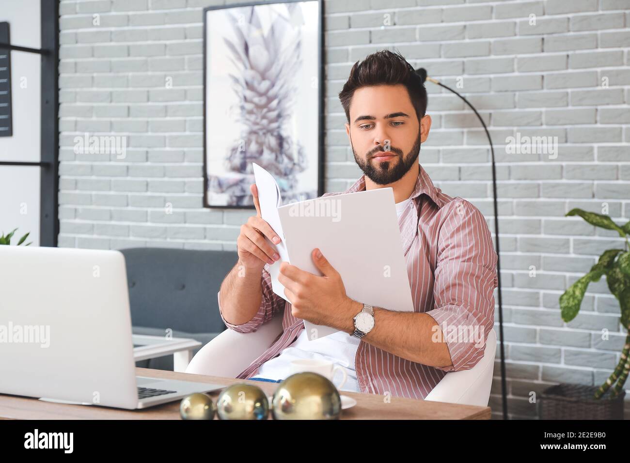Young man reading magazine at home Stock Photo - Alamy