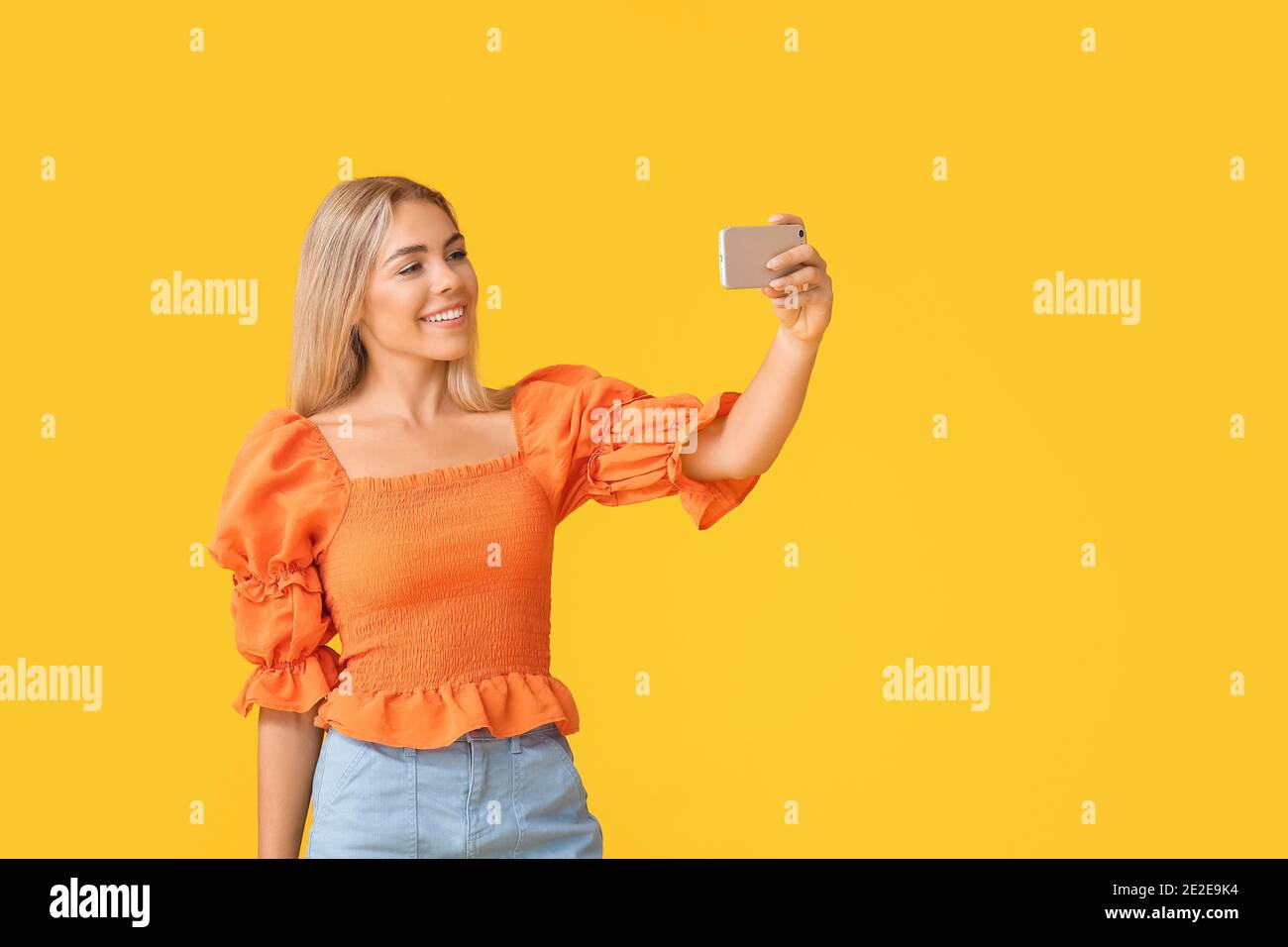 Teenage girl taking selfie on color background Stock Photo - Alamy