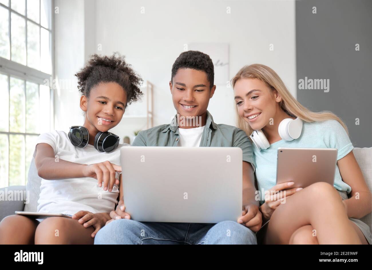 Teenagers with different devices at home Stock Photo - Alamy