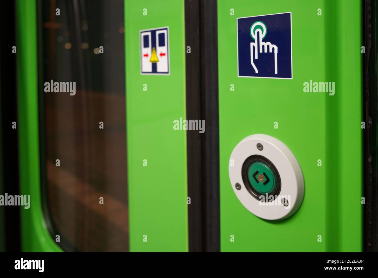 Close-up view at Green Push button for open the door on train's door of ...