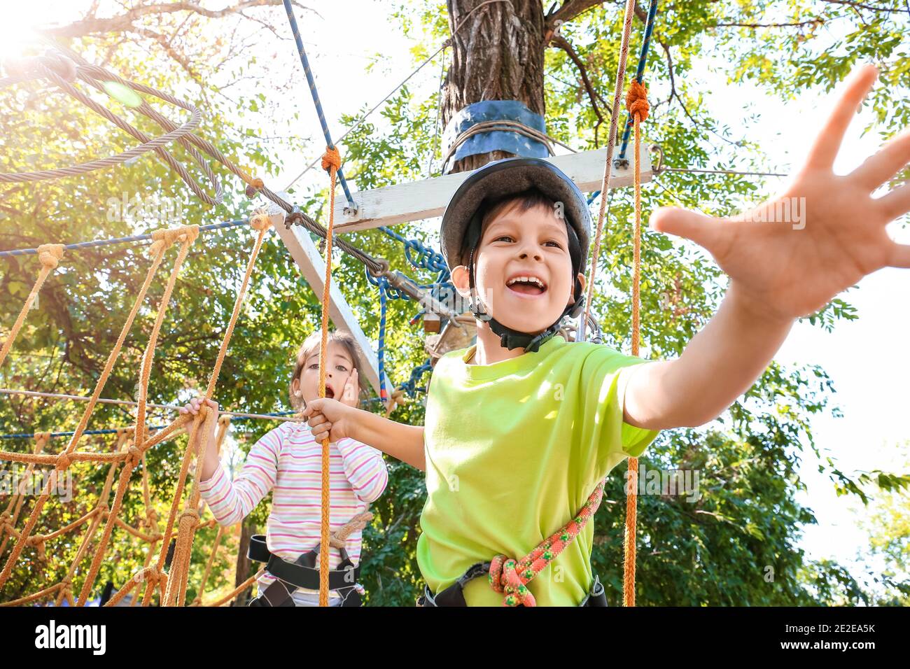 Children climbing in adventure park Stock Photo - Alamy