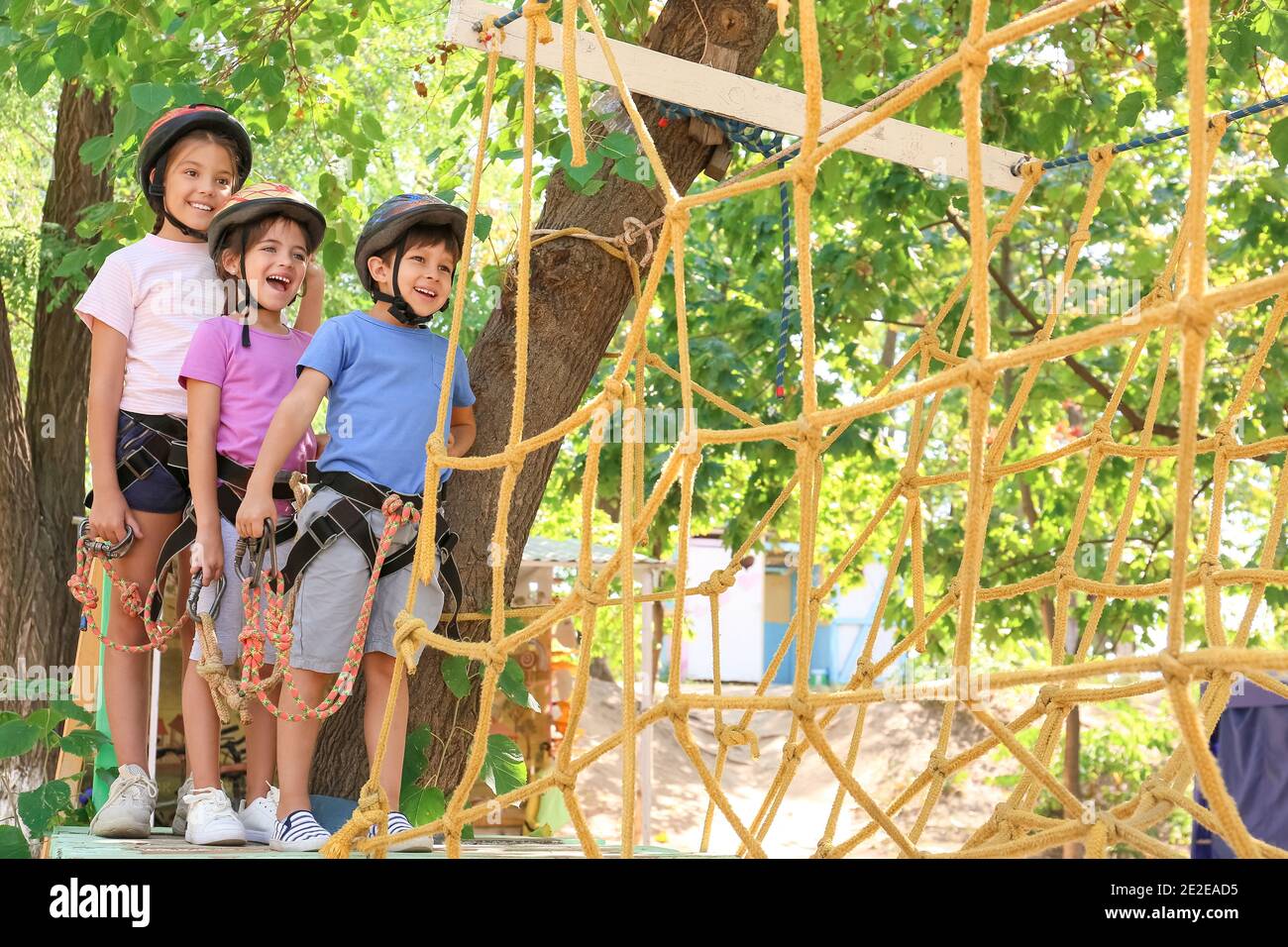 Children climbing in adventure park Stock Photo - Alamy