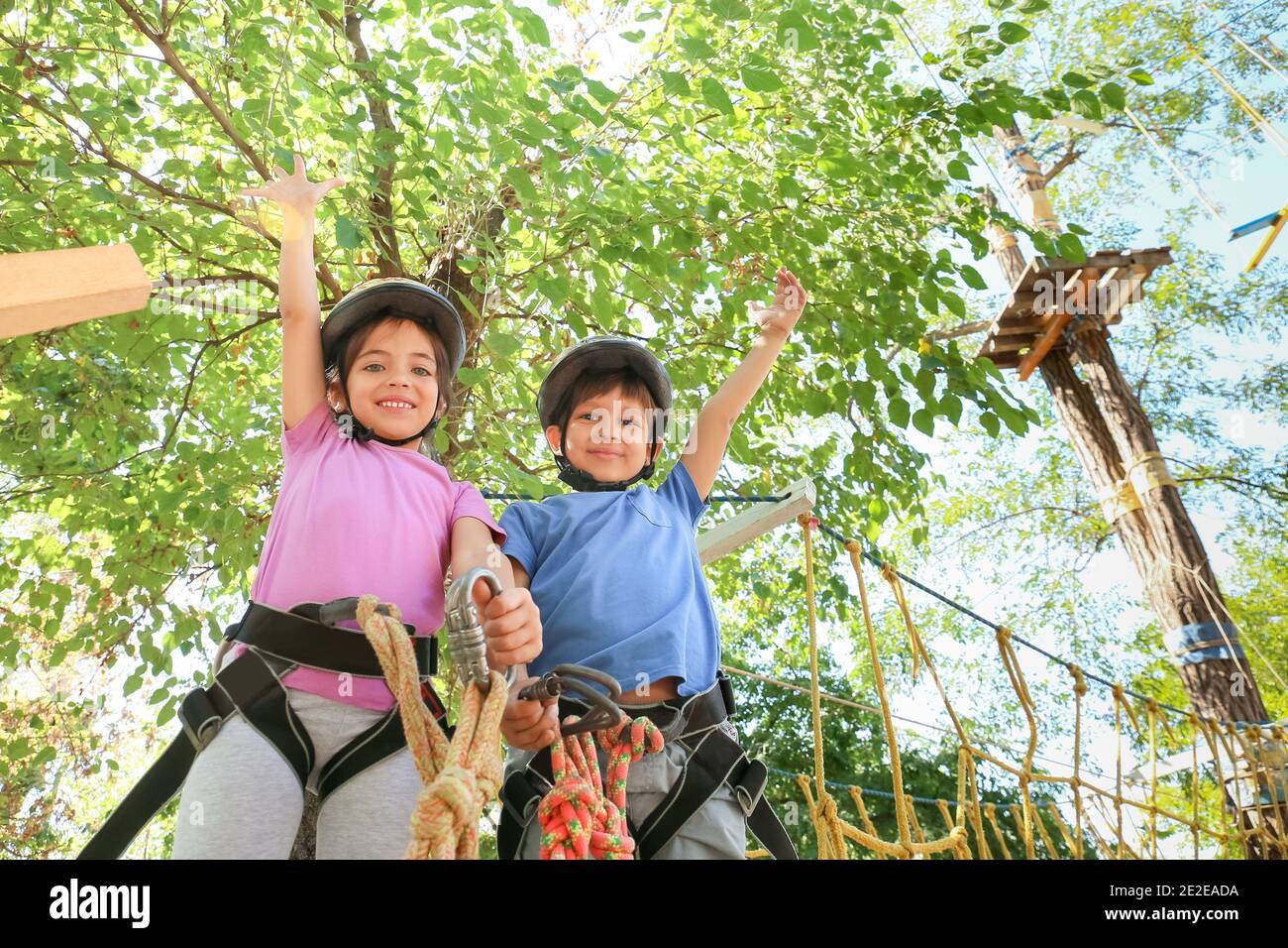 Happy children climbing in adventure park Stock Photo - Alamy
