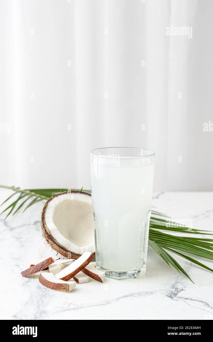 Glass of fresh coconut water on table Stock Photo - Alamy