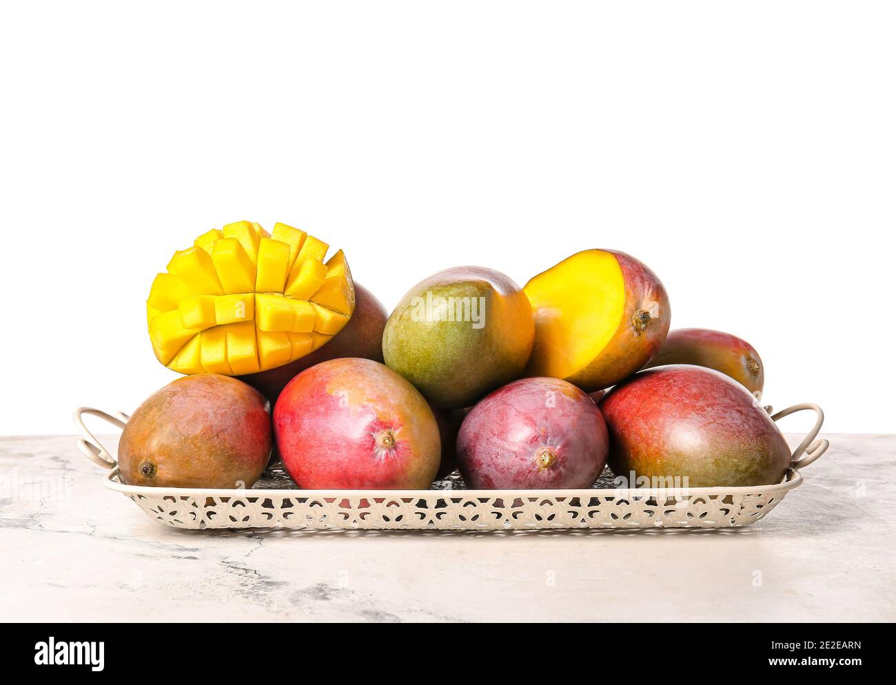 Sweet ripe mangoes on table against white background Stock Photo - Alamy