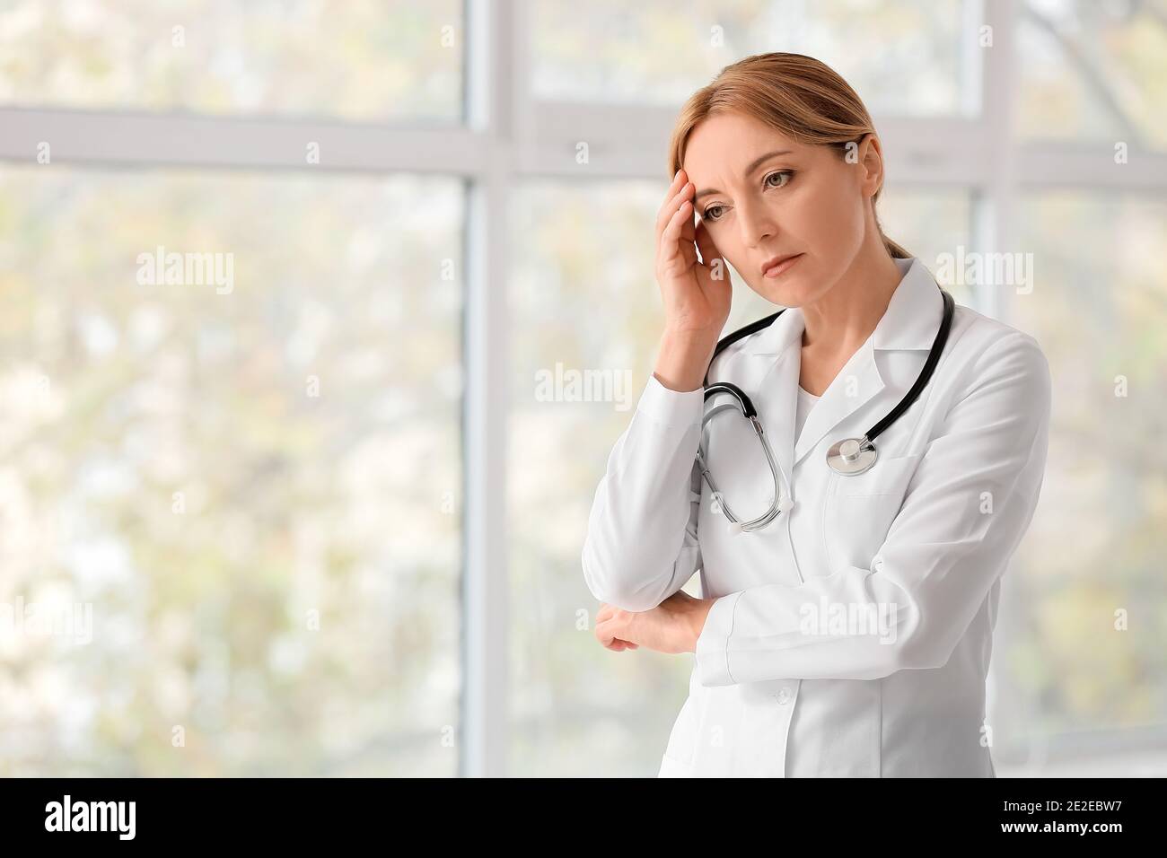 Sad female doctor in clinic Stock Photo - Alamy