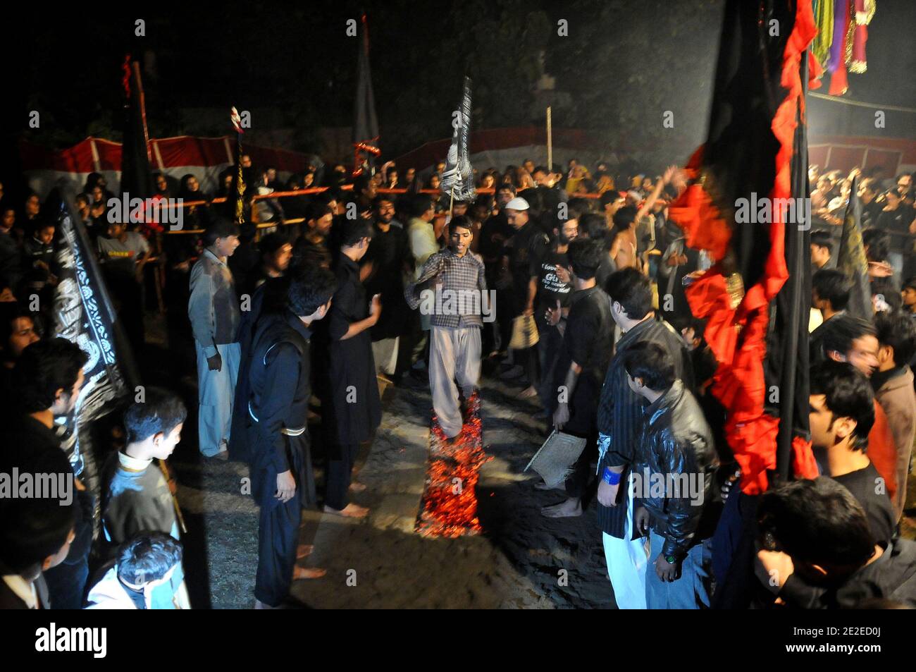 A Shia Muslim walks on fire at a ceremony during the Ashura festival ...