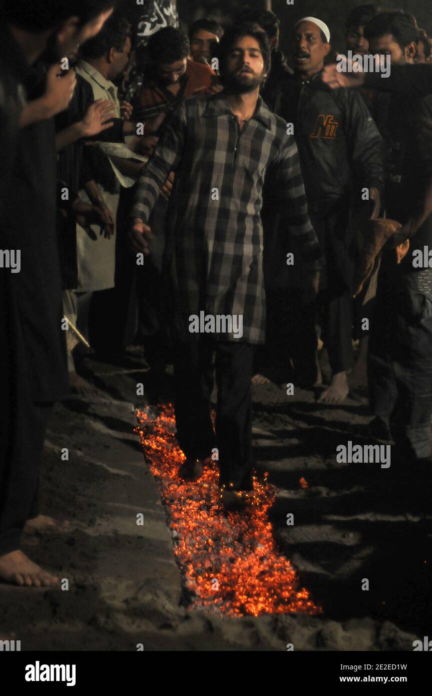 A Shia Muslim walks on fire at a ceremony during the Ashura festival ...
