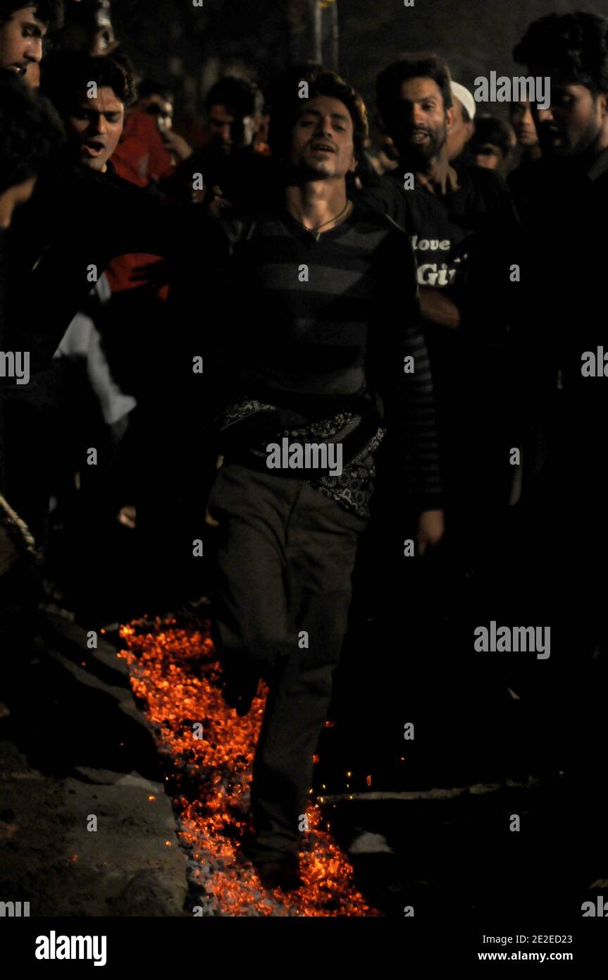 A Shia Muslim walks on fire at a ceremony during the Ashura festival ...