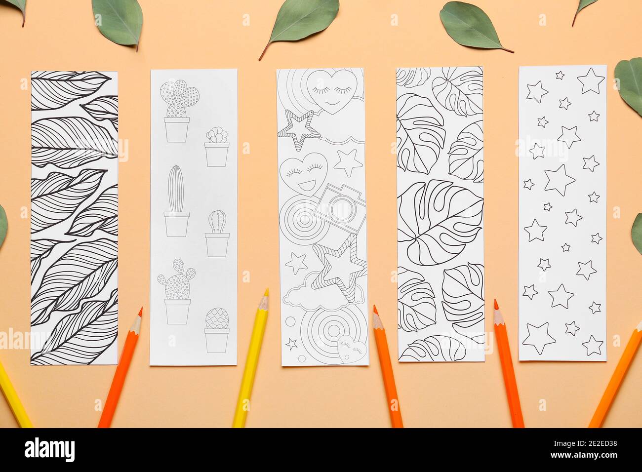 Cute bookmarks with pencils on color background Stock Photo - Alamy